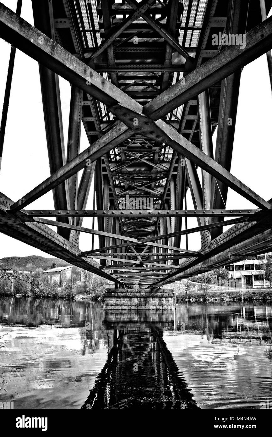 Riveted bridge seen from underneath. Black and white high contrast ...