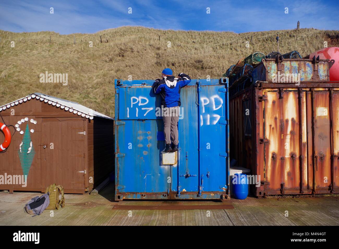 Young British Man On Top of a Used Storage Shipping Container. Port ...