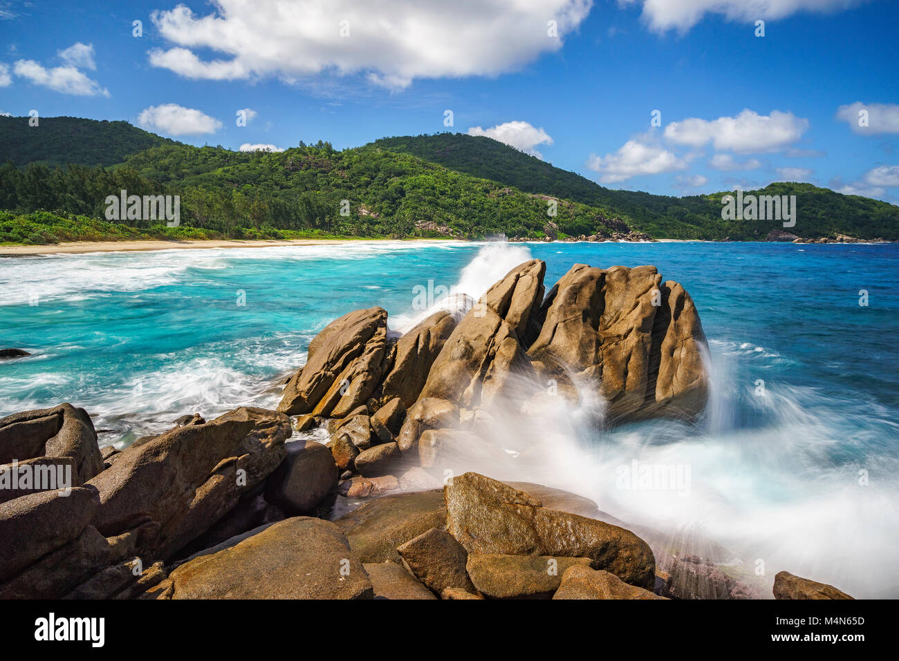Splashing water withe big water fountains on a wild tropical beach with ...