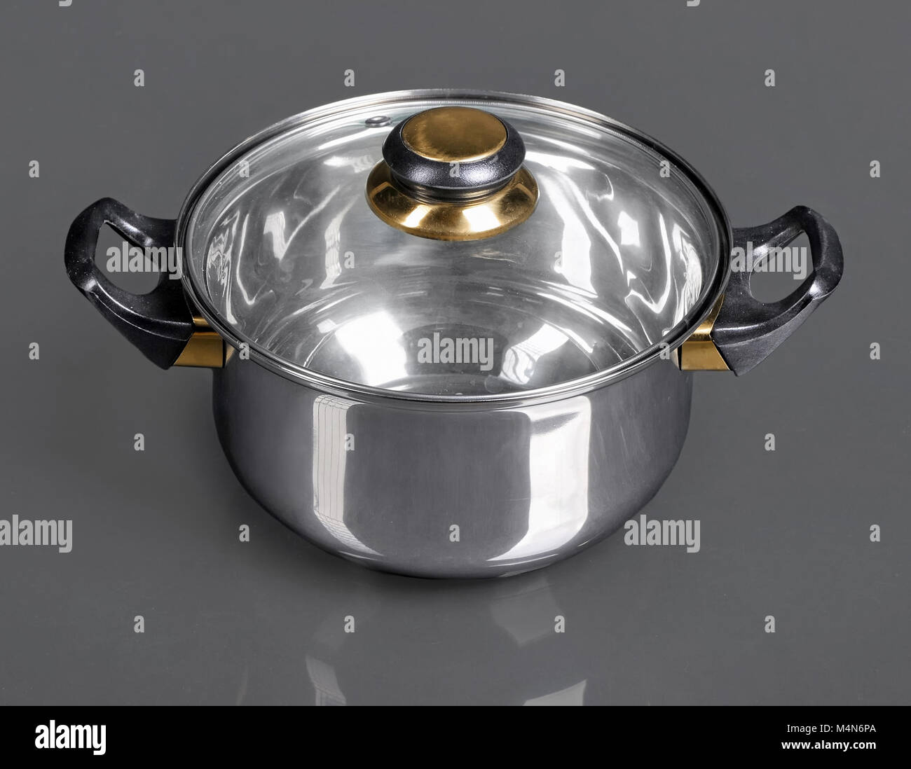 Metallic pan on gray Stock Photo - Alamy