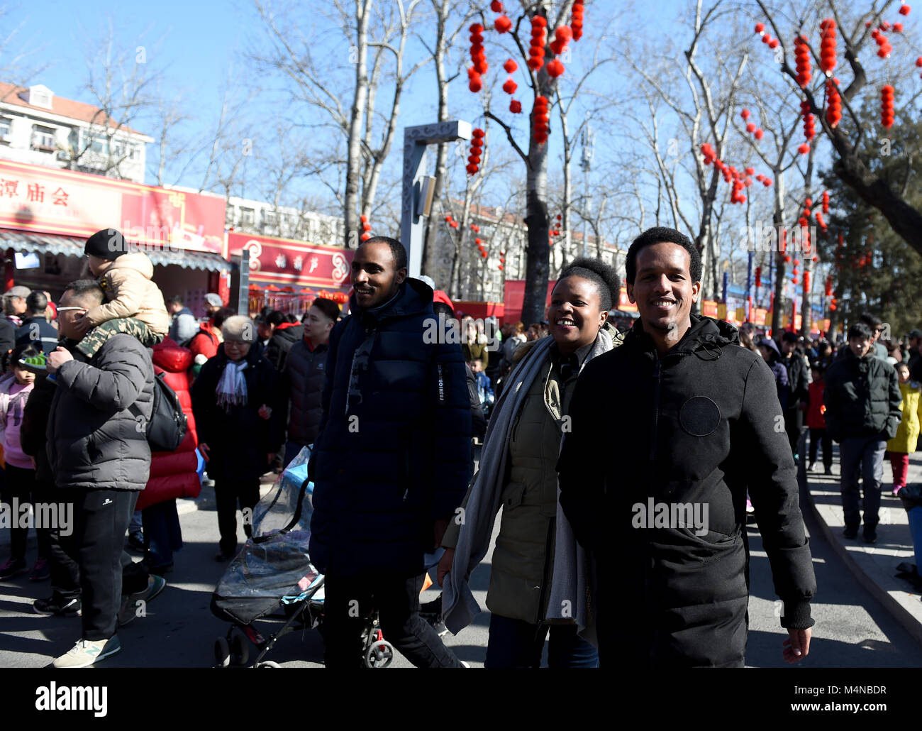Beijing, China. 16th Feb, 2018. Tourists visit a temple fair in ...