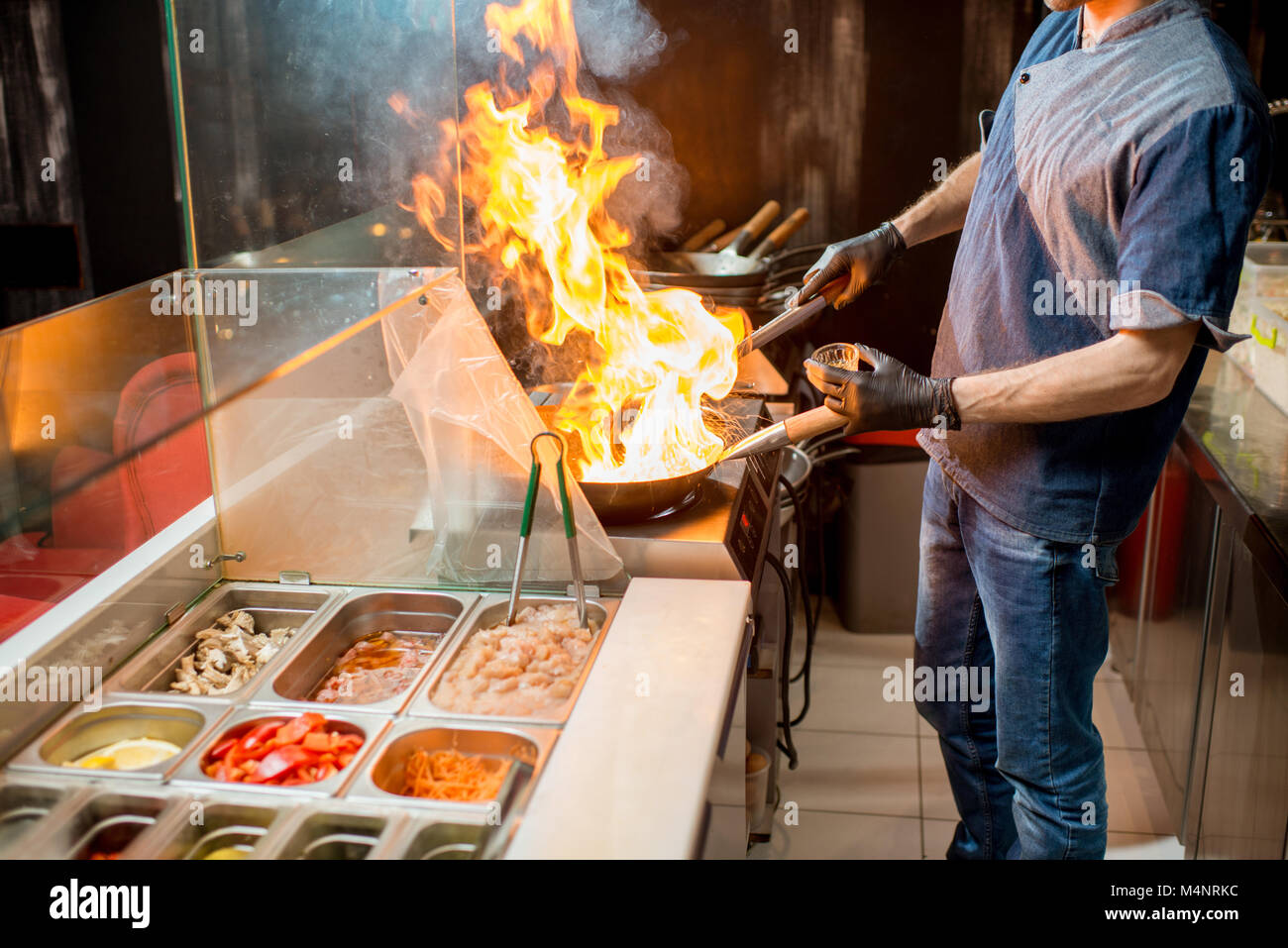 Chief cook cooking at the asian kitchen Stock Photo - Alamy