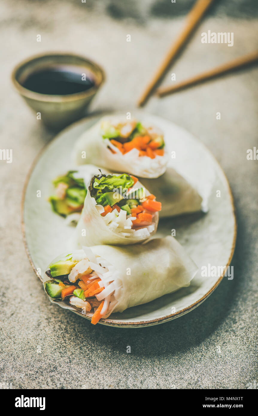 Shrimp and vegetable rice paper spring rolls with sauce on ceramic ...