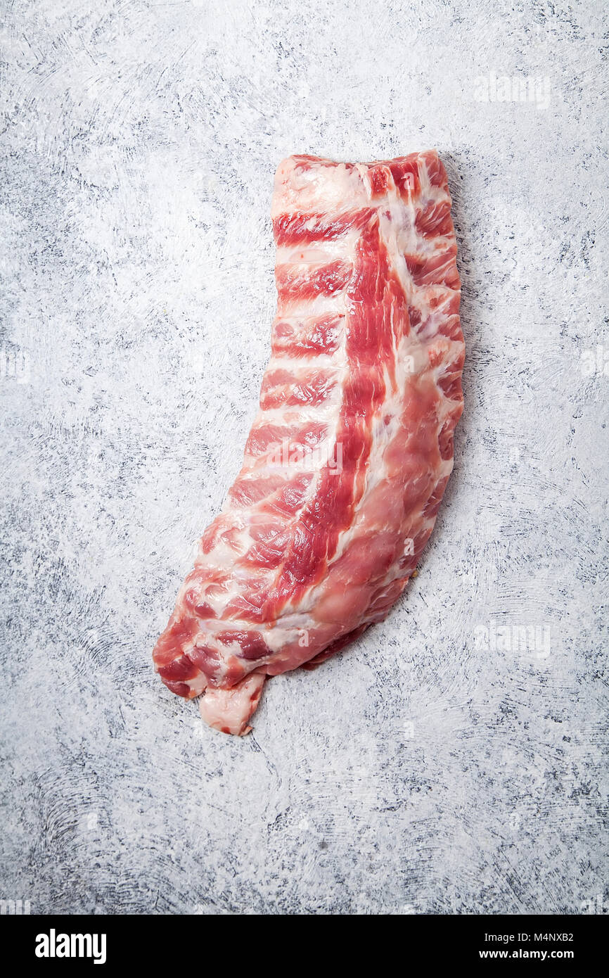 Uncooked pork ribs on textured gray background. Vertical composition ...