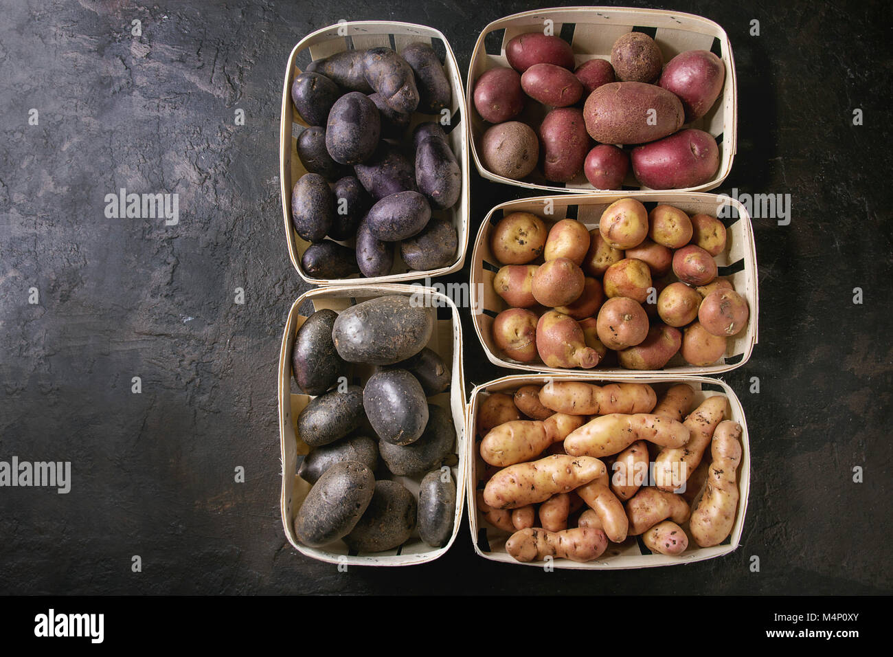Variety of raw uncooked organic potatoes different kind and colors red ...