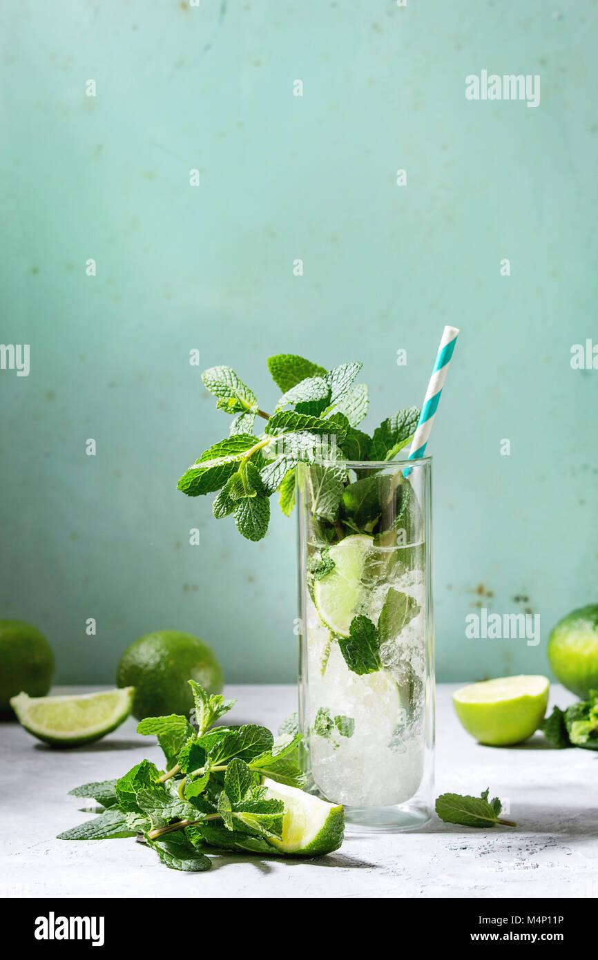 Glass of classic mojito cocktail with fresh mint, limes, crushed ice ...