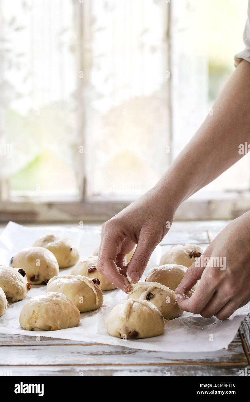 Raw unbaked buns. Ready to bake homemade Easter traditional hot cross ...