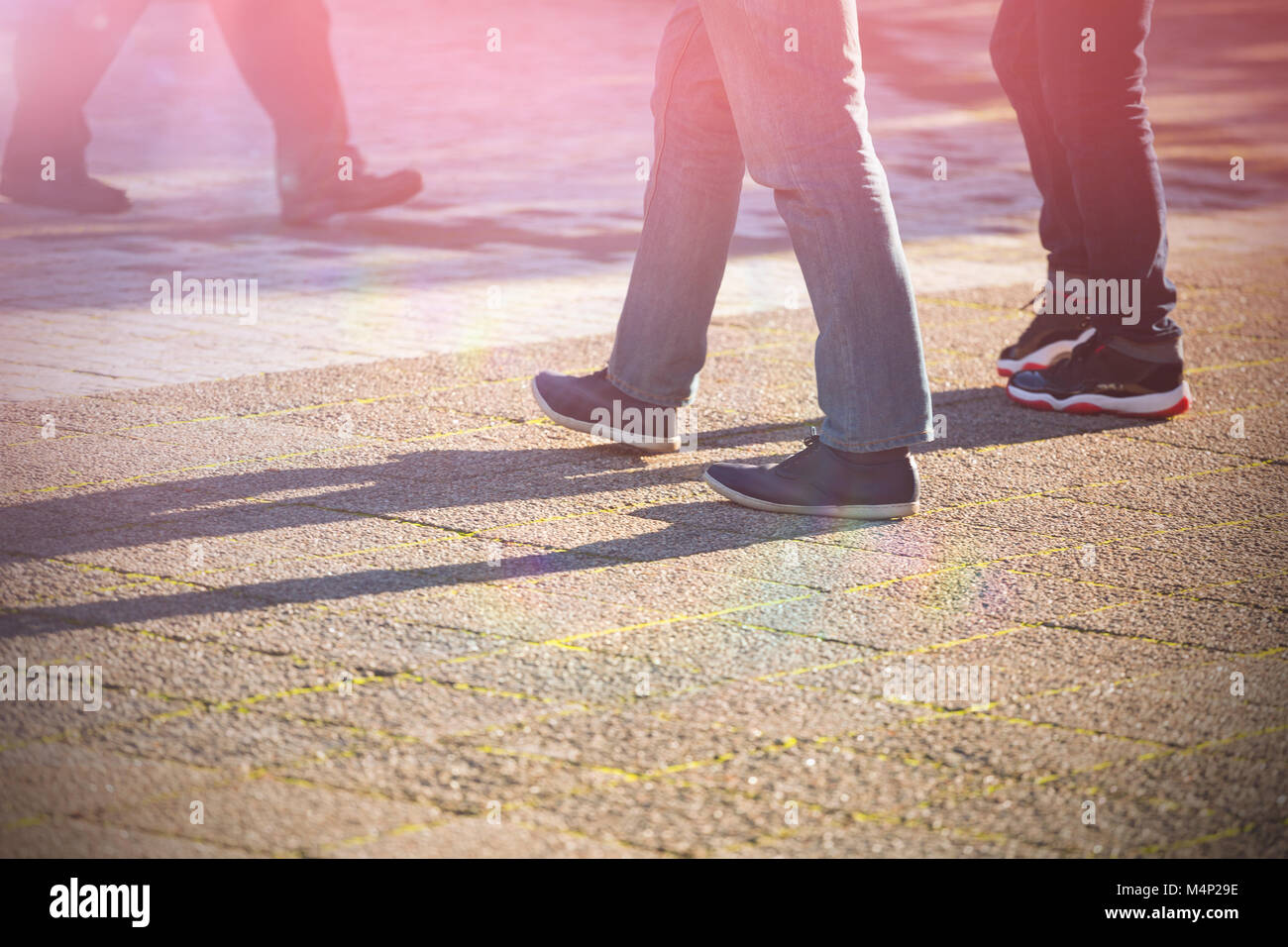 People walking on sidewalk Stock Photo - Alamy