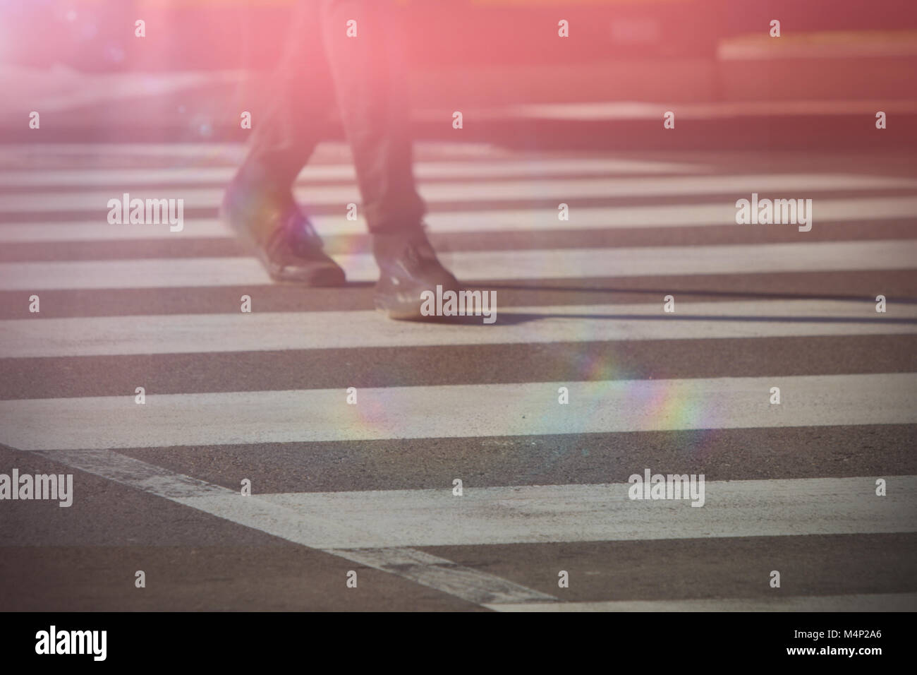 Person walking on zebra crossing Stock Photo - Alamy