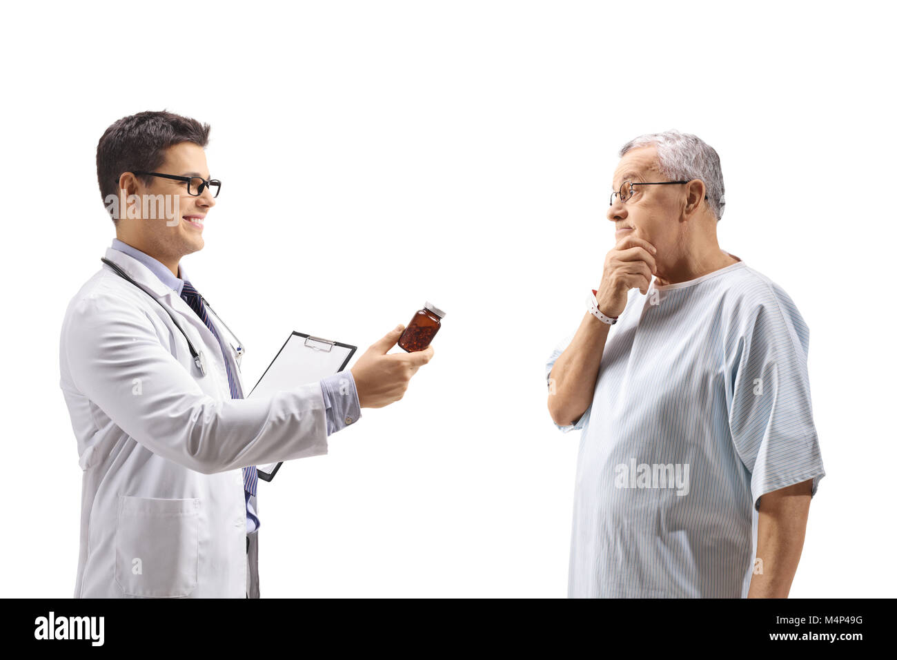 Doctor giving a bottle of pills to a concerned elderly patient isolated ...