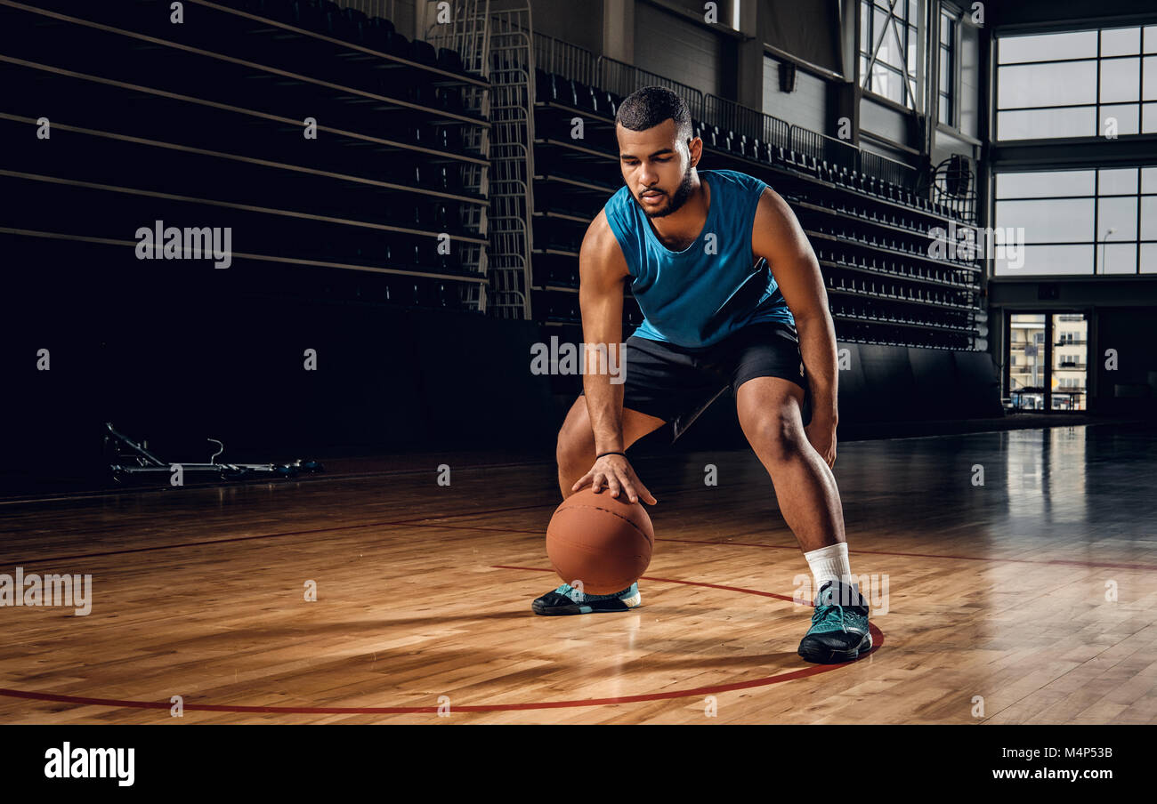 Full body portrait of Black professional basketball player in an action ...