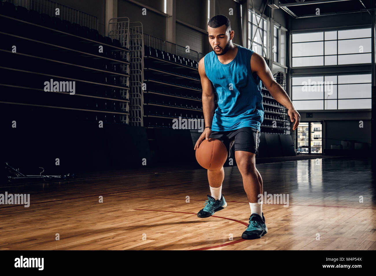 Full body portrait of Black professional basketball player in an action ...