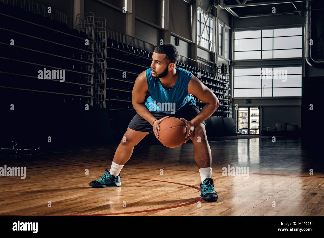 Full body portrait of Black professional basketball player in an action ...