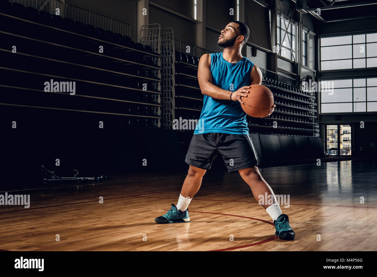 Full body portrait of Black professional basketball player in an action ...