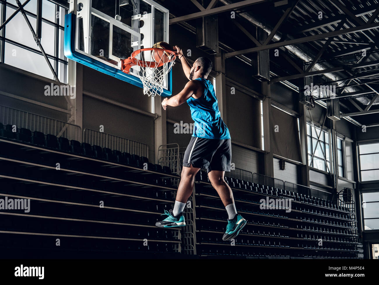 Black professional Black basketball player in action in a basketball ...