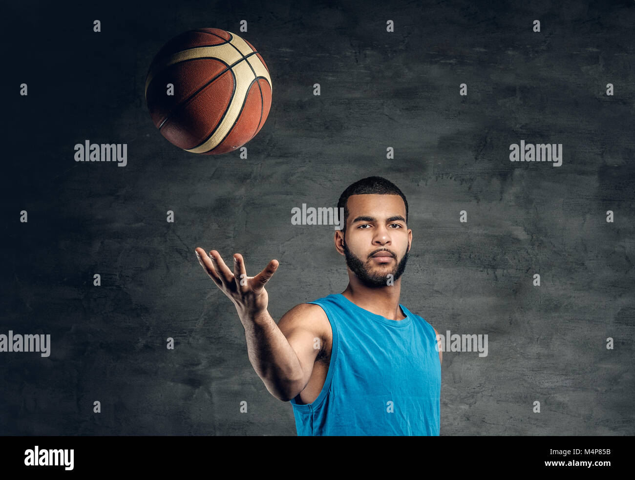 A black basketball player catching a ball. studio shot Stock Photo - Alamy