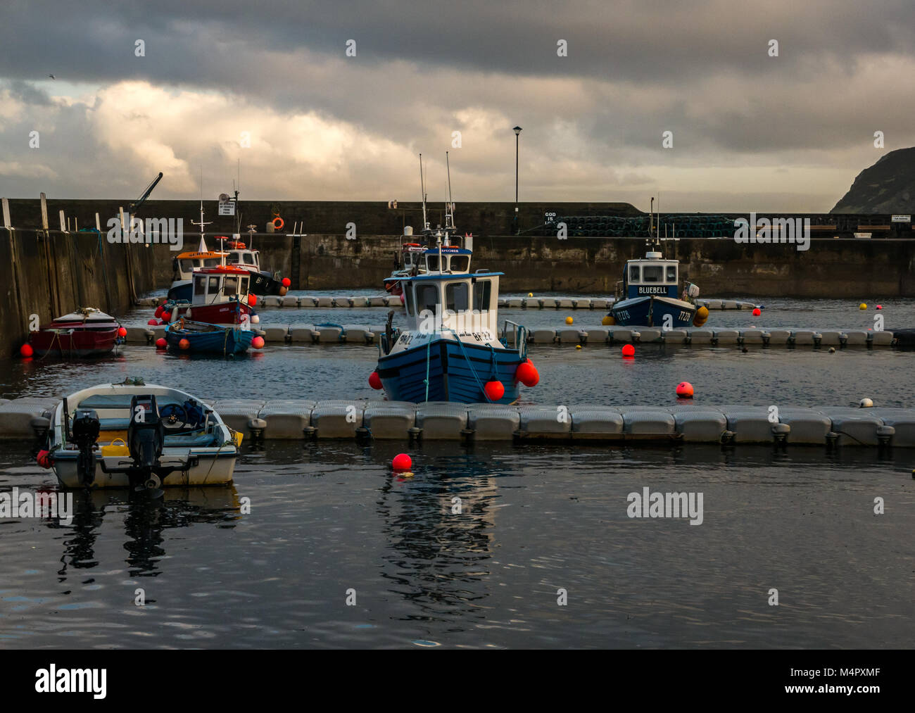 Colourful small fishing boats in harbour, picturesque seaside village ...