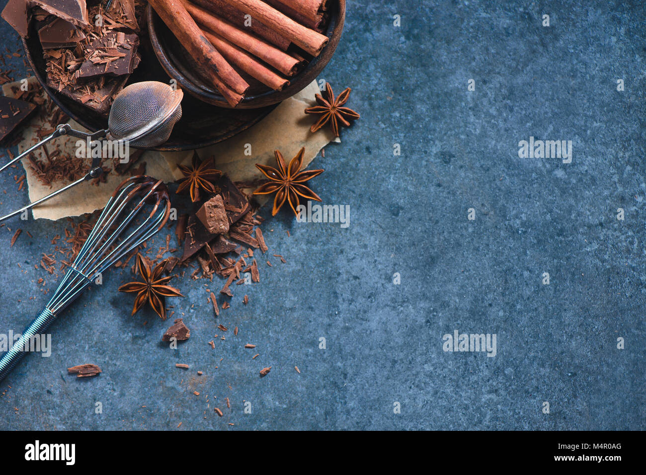 Cooking sweets on a marble kitchen table. Whisk and cocoa strainer with ...