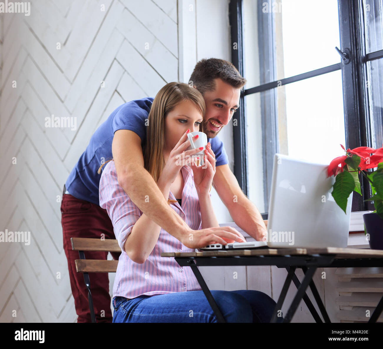 Multi ethnic student using laptop in apartments Stock Photo - Alamy
