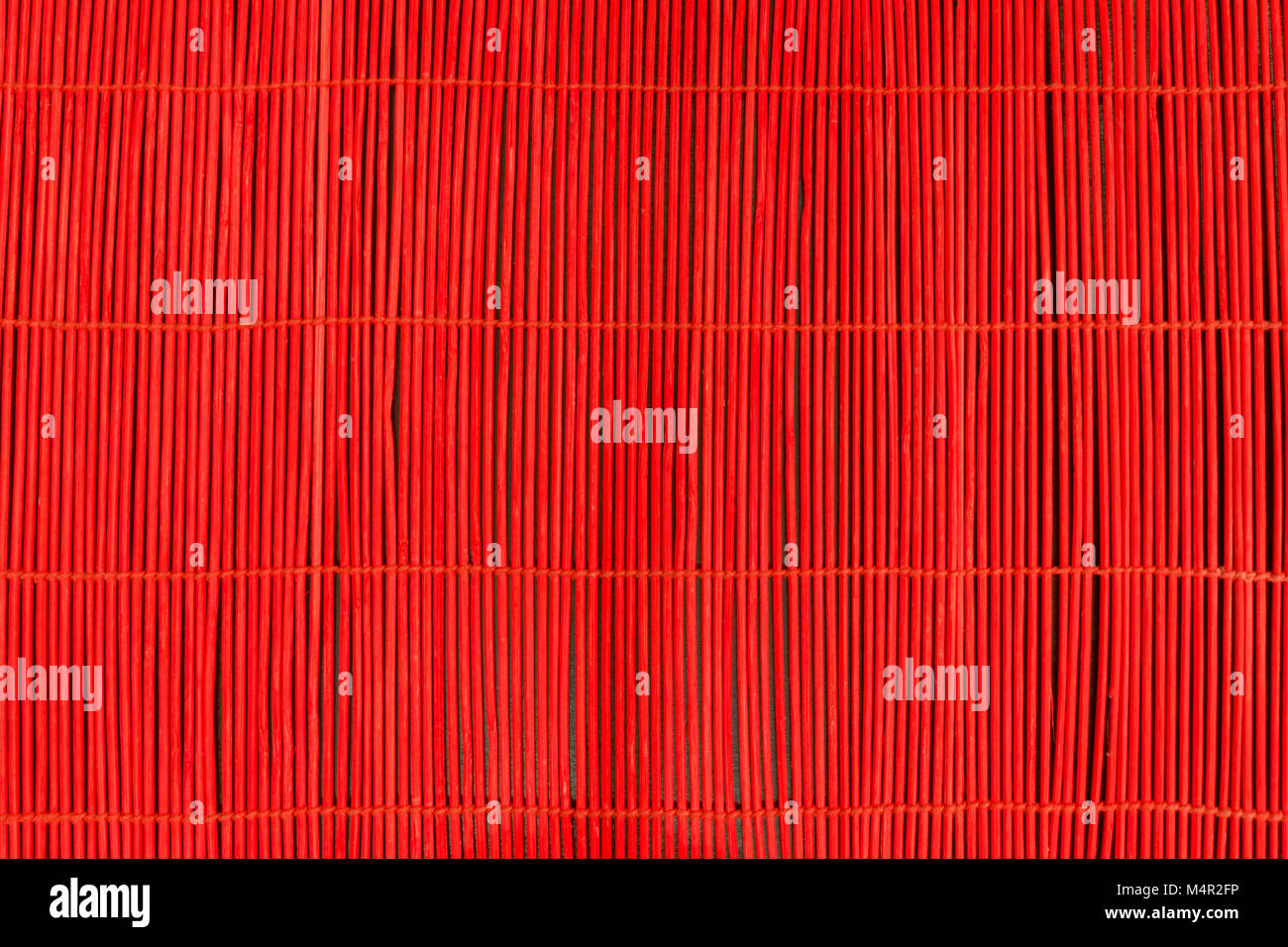 Red sticks in dark background. Red sticks tied up between each other ...