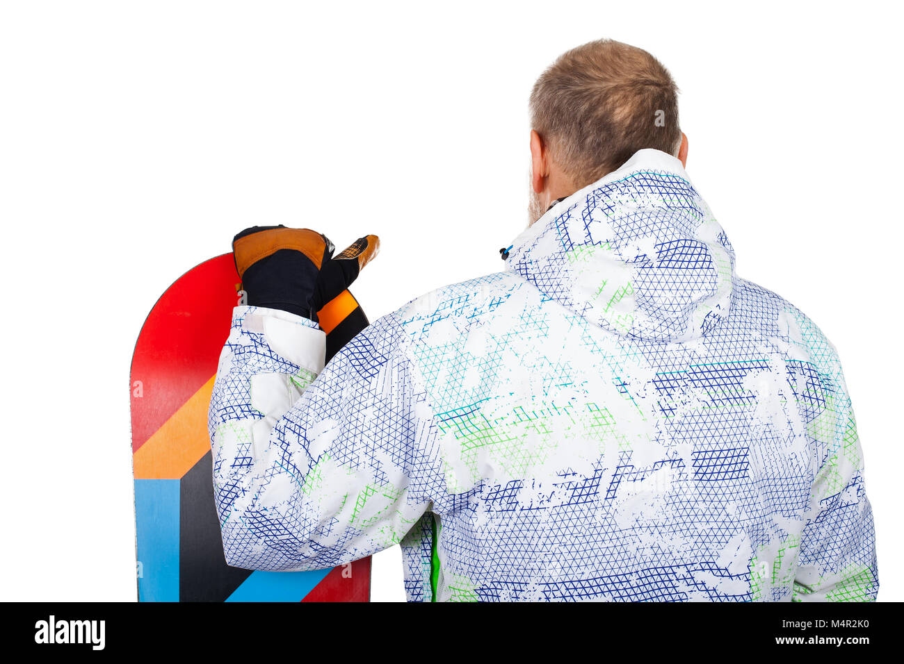 Active senior man holding his snowboard on isolated background - back ...