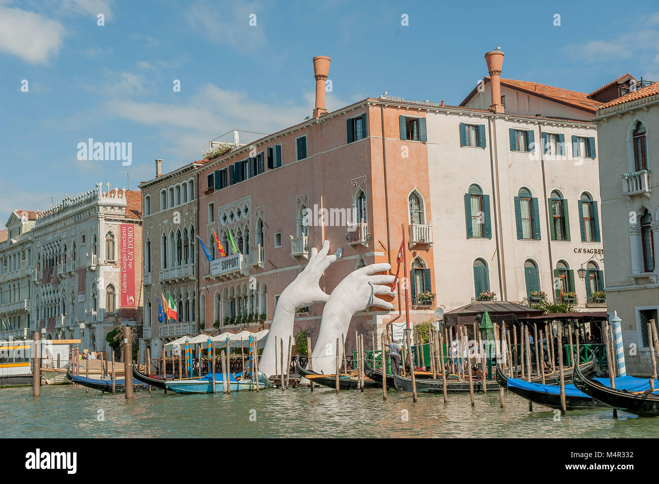 VENICE, ITALY - August 2017: Monumental hands rise from the water in ...