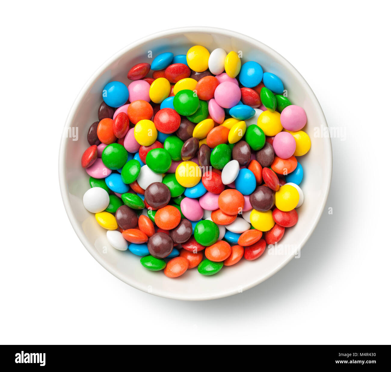 Colorful chocolate candy pills in bowl isolated on white background ...