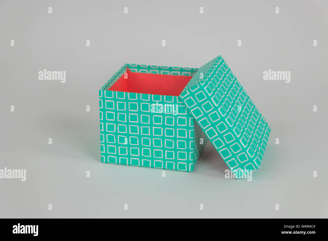 Turquoise box with red innerside and the lid off Stock Photo - Alamy