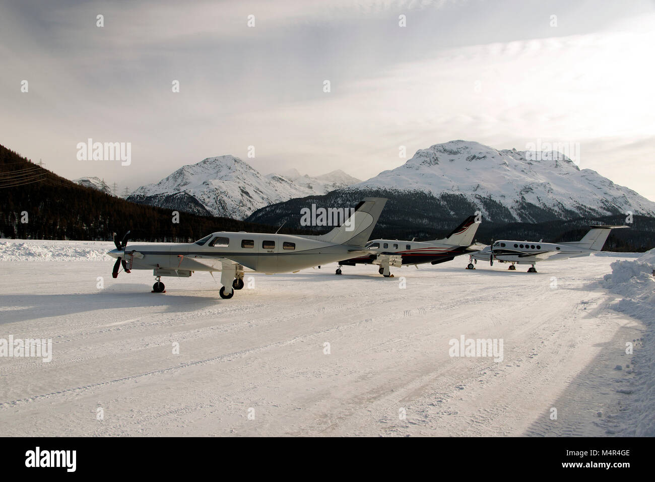 Private jets and a propeller type airplane taking off in the airport of ...