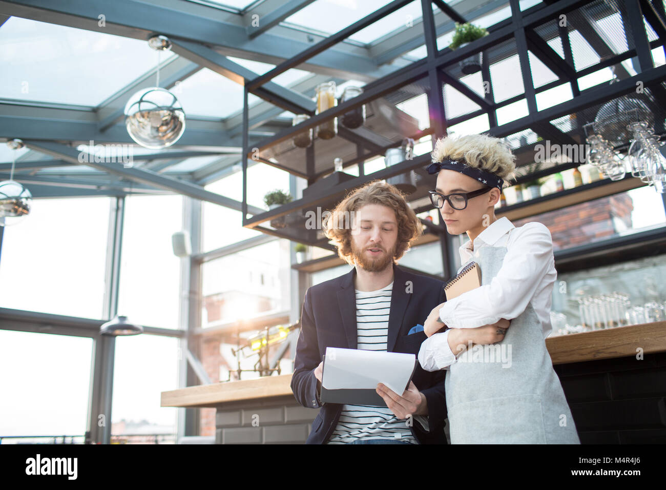 Showing contract to waitress Stock Photo - Alamy
