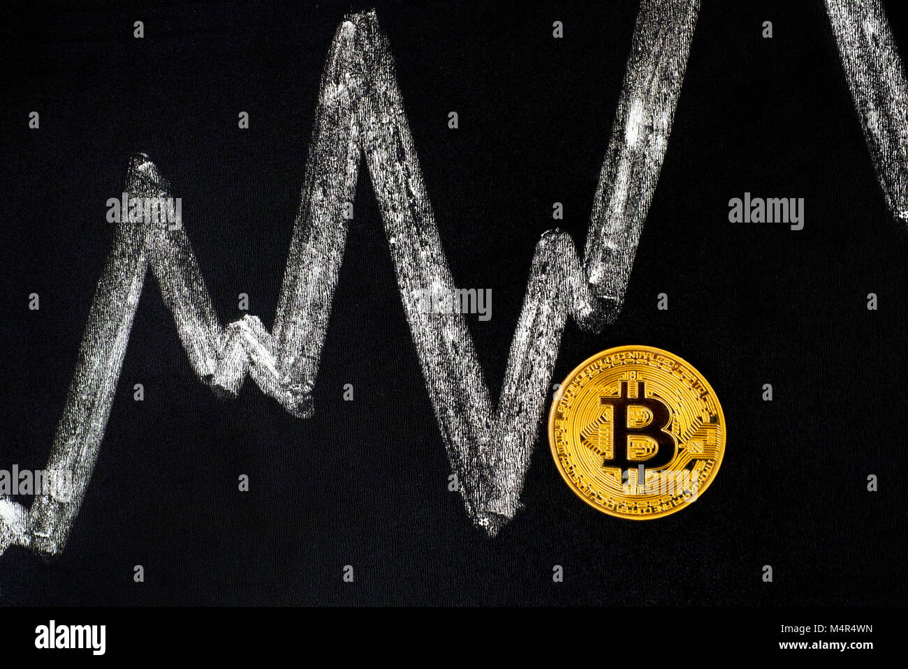 Golden Bitcoin coin on blackboard with chalk drawing graph Stock Photo ...
