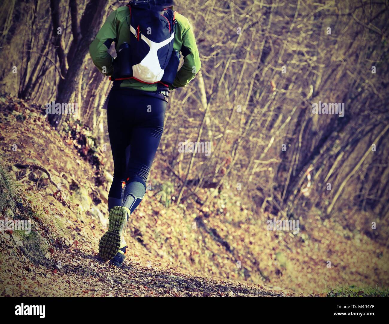 Athlete runner from behind with vintage effect during the racing race ...