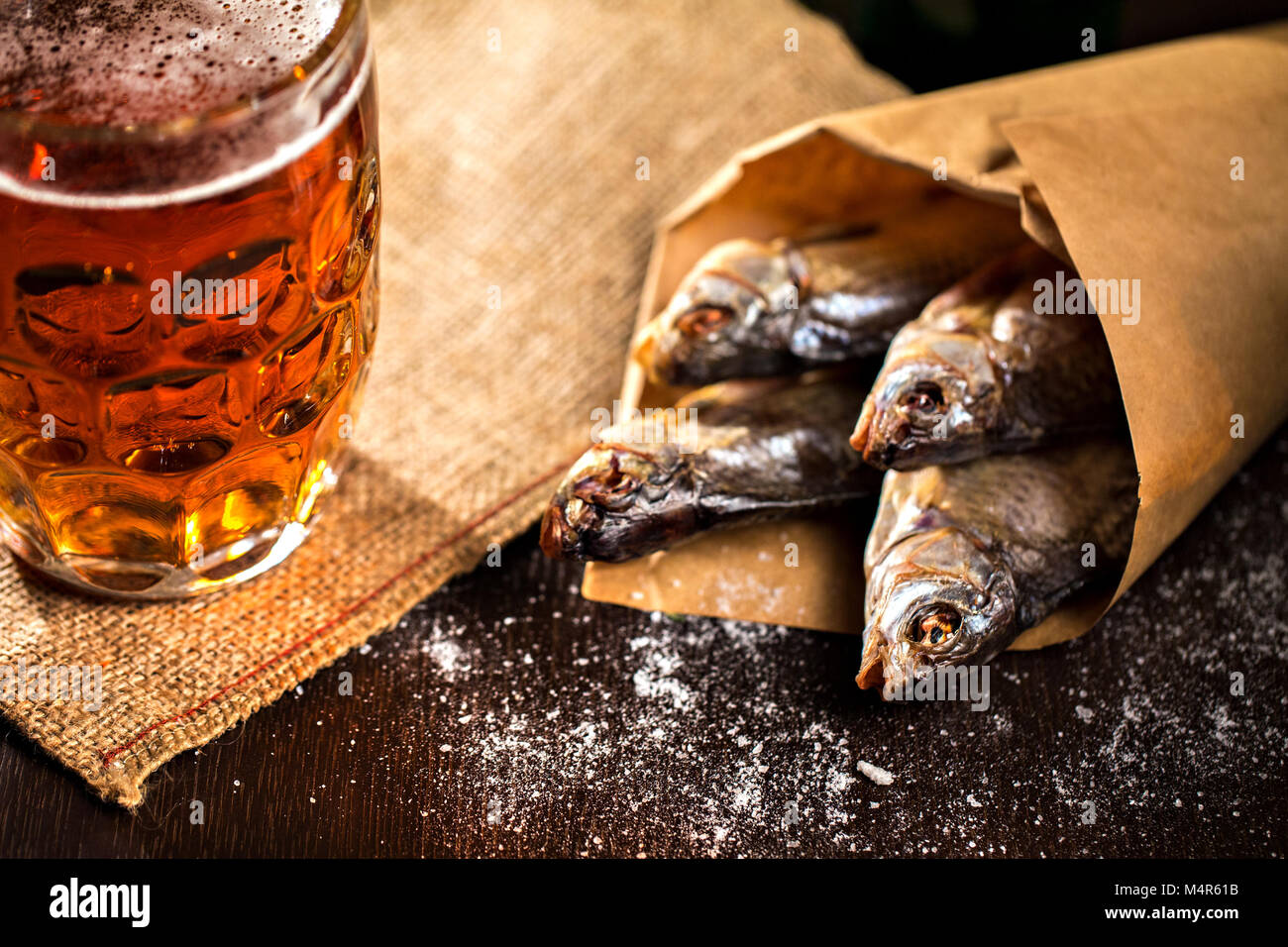 dried fish and vintage glass of beer on a black background Stock Photo ...