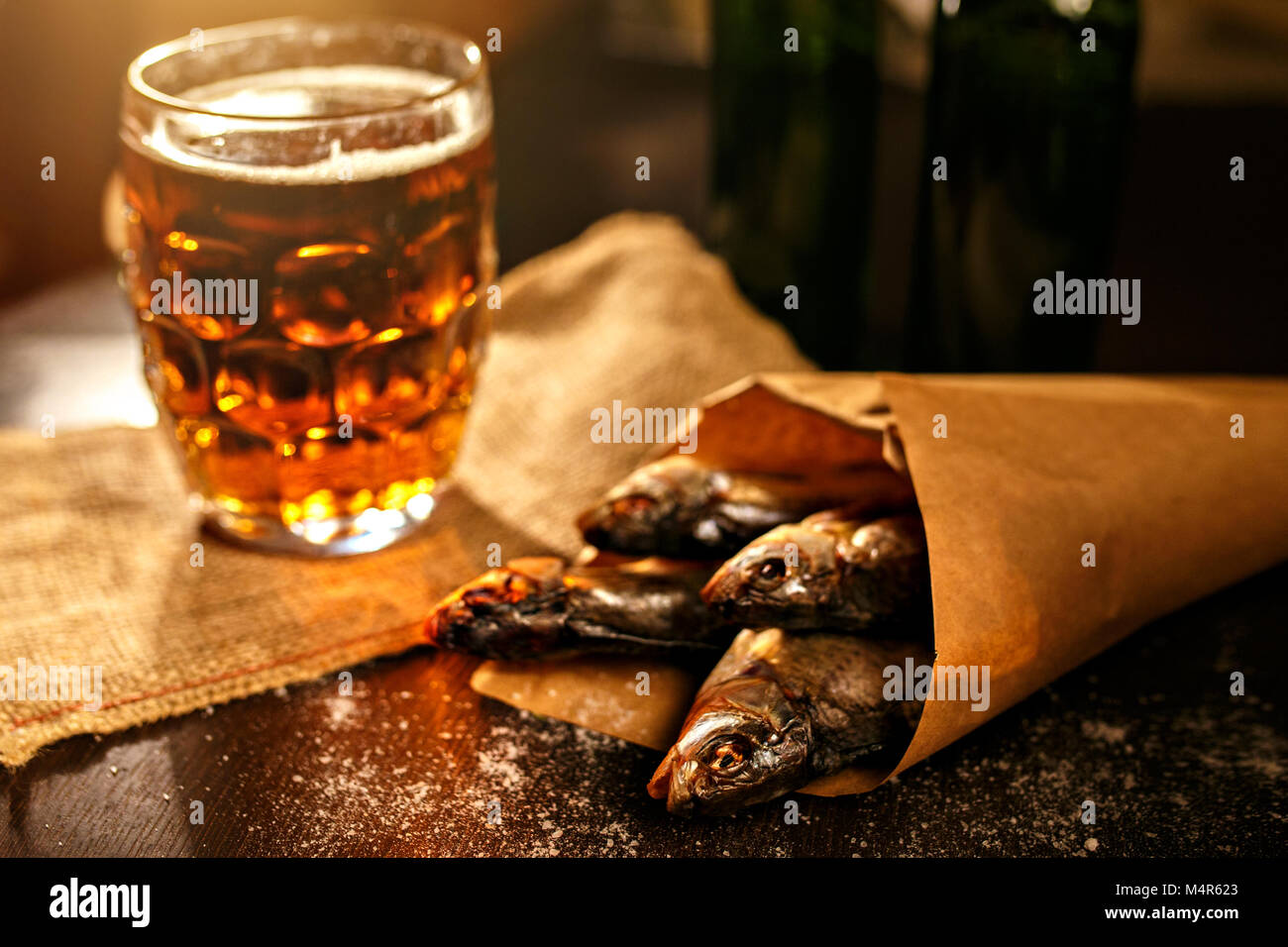 dried fish and vintage glass of beer on a black background Stock Photo ...