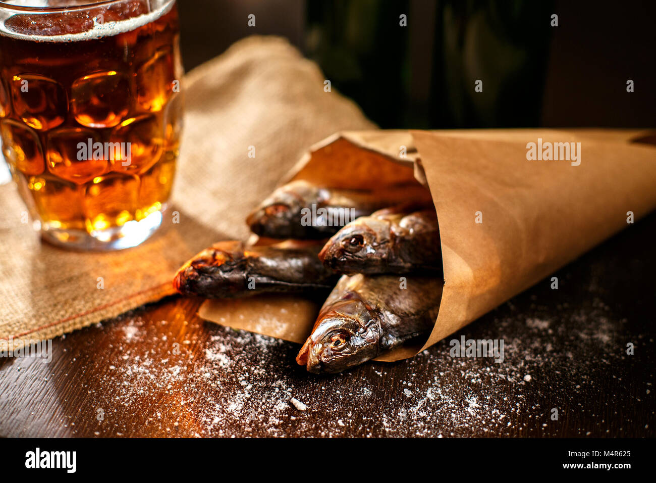 dried fish and vintage glass of beer on a black background Stock Photo ...