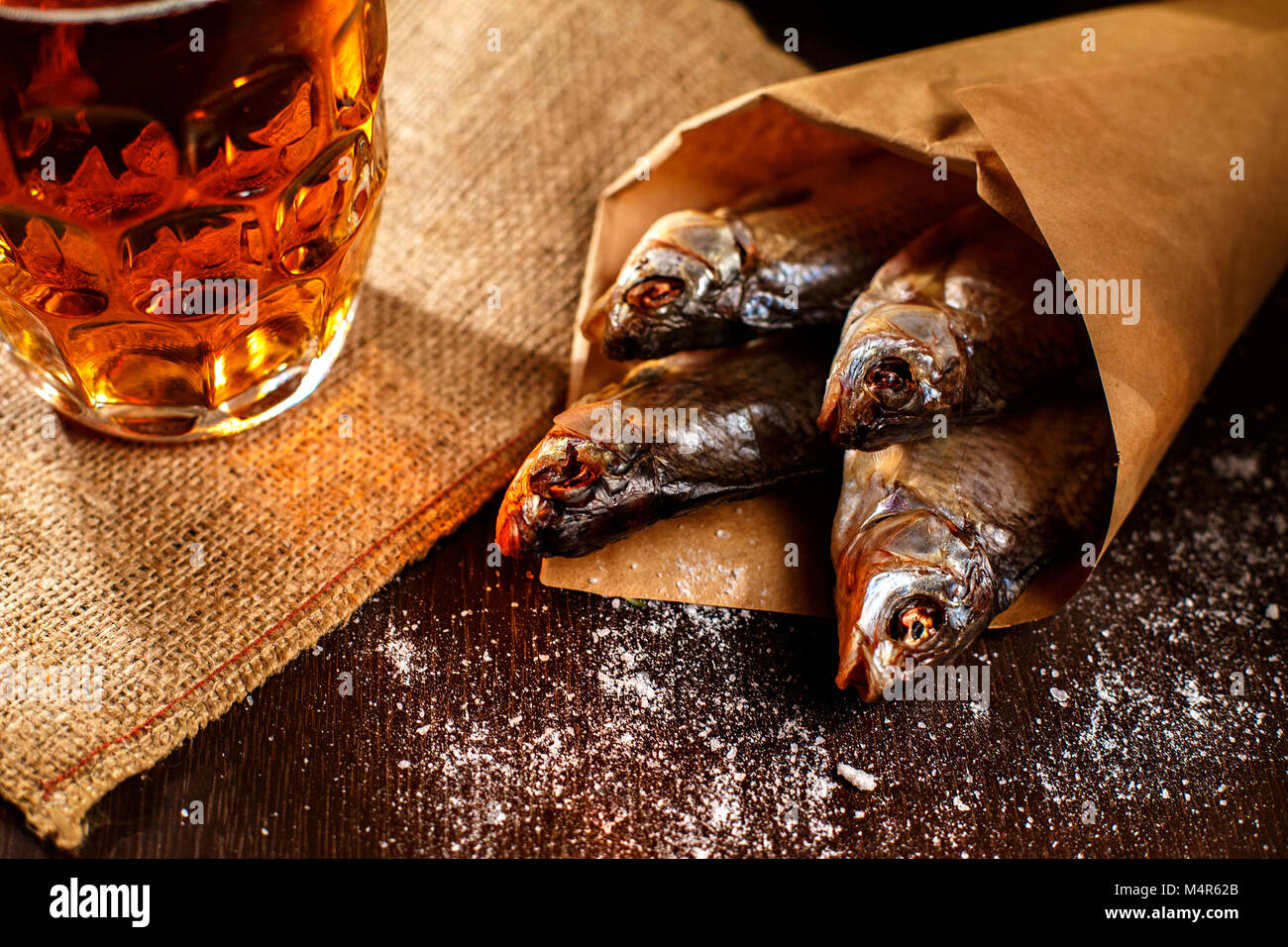 dried fish and vintage glass of beer on a black background Stock Photo ...