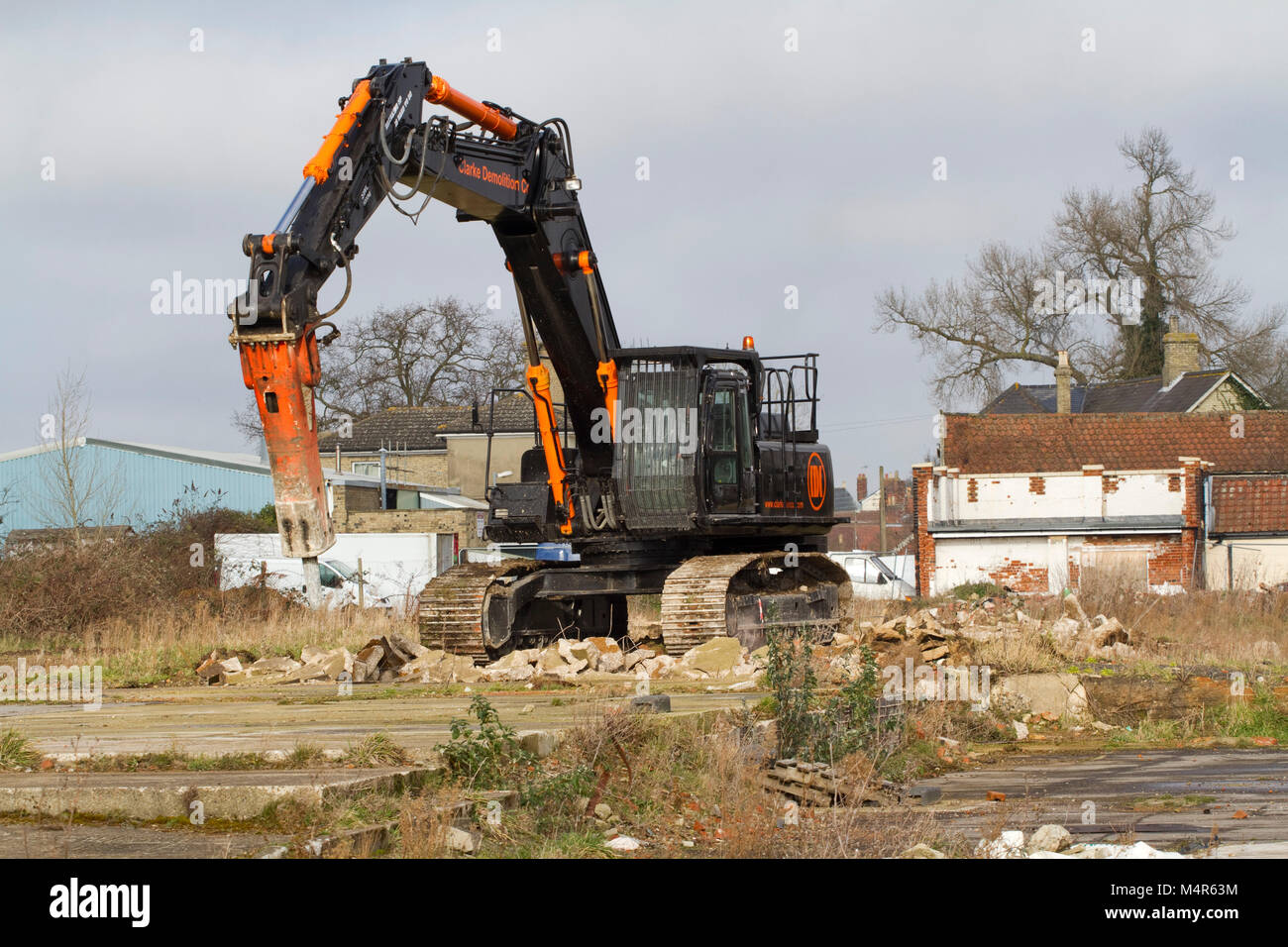 Large tracked machine breaking up concrete Stock Photo - Alamy