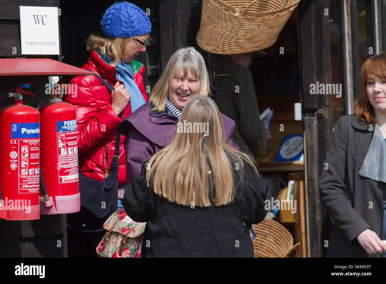 Women in conversation at a craft and art fair Stock Photo - Alamy