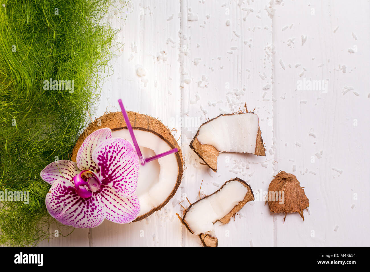 Coconut on wooden table on bright blurred background Stock Photo - Alamy