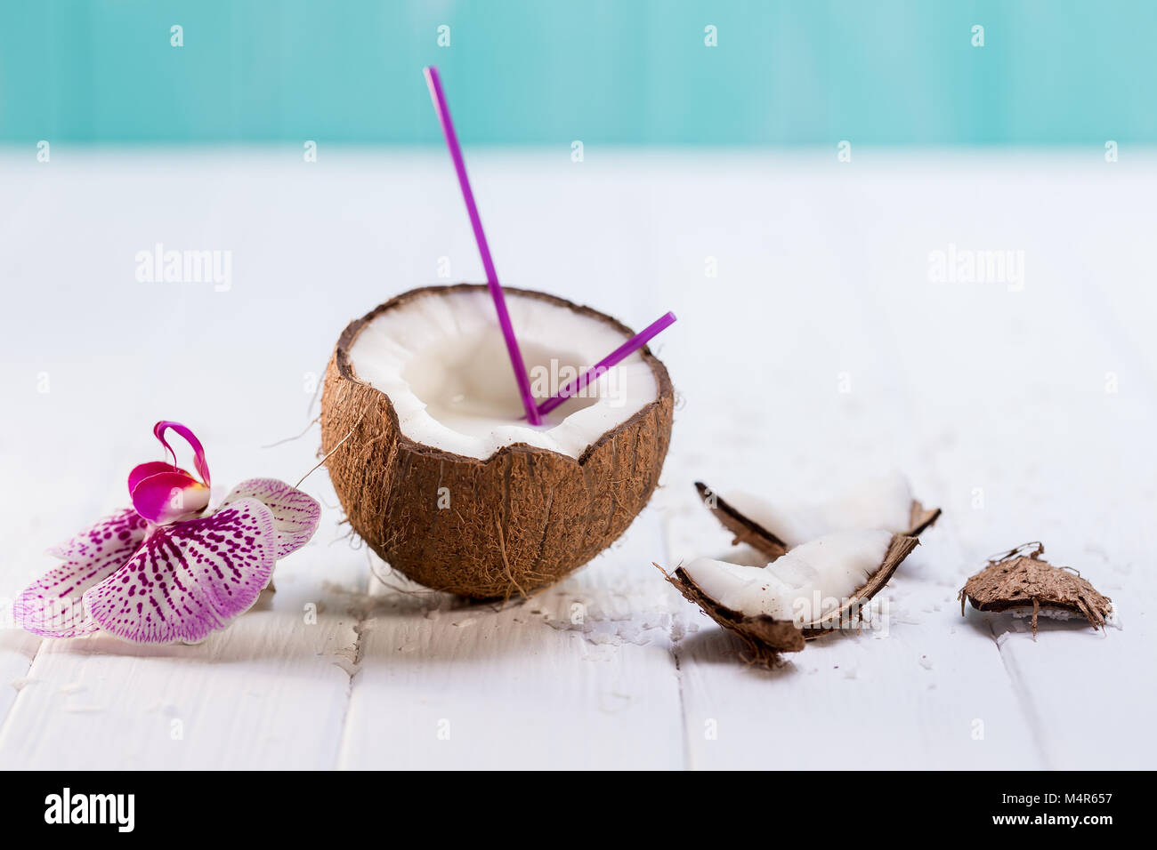 Coconut on wooden table on bright blurred background Stock Photo - Alamy