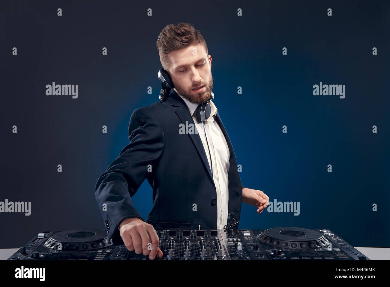 Closeup portrait of confident DJ with stylish hair style and headphones ...