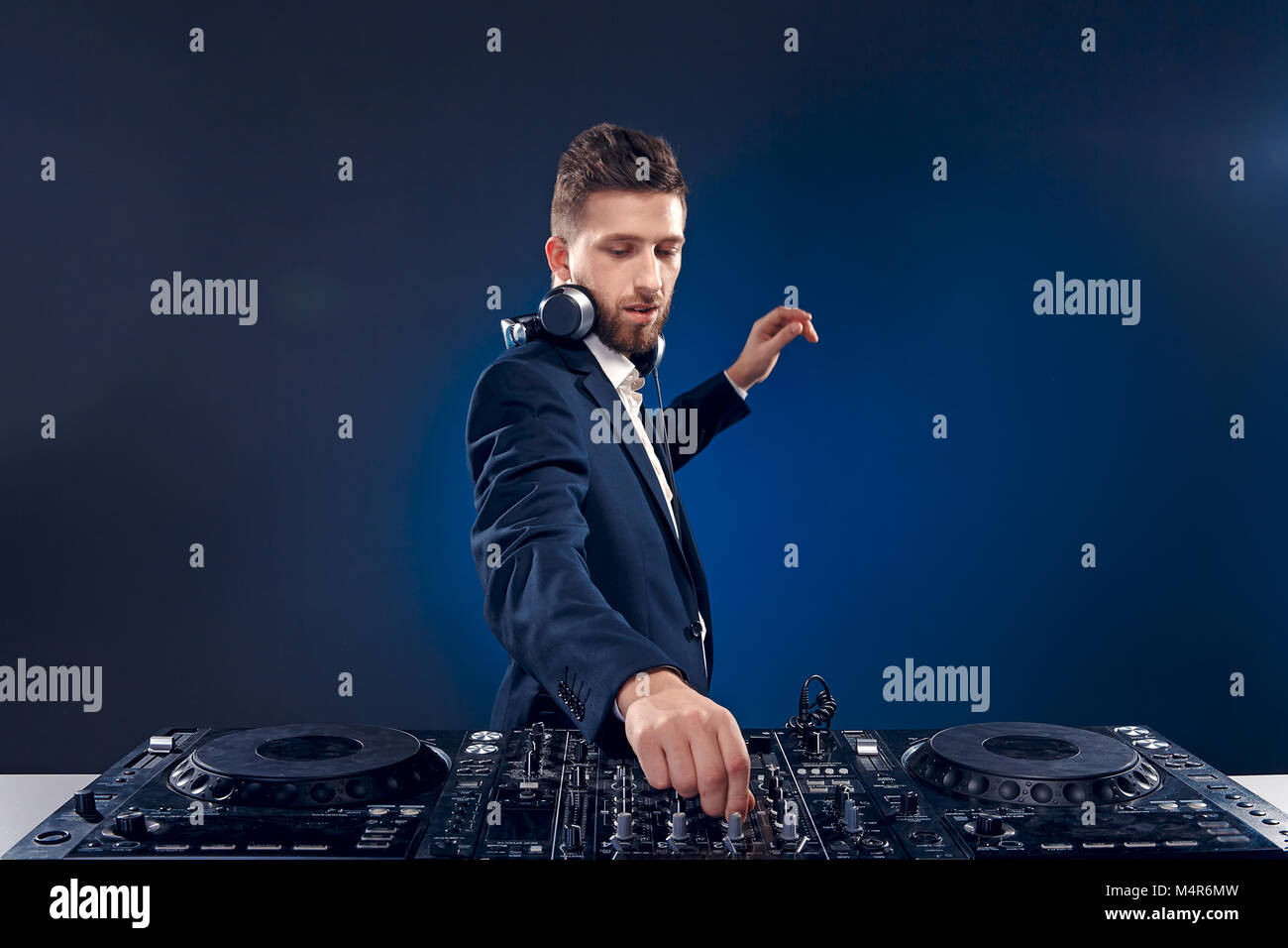 Closeup portrait of confident DJ with stylish hair style and headphones ...