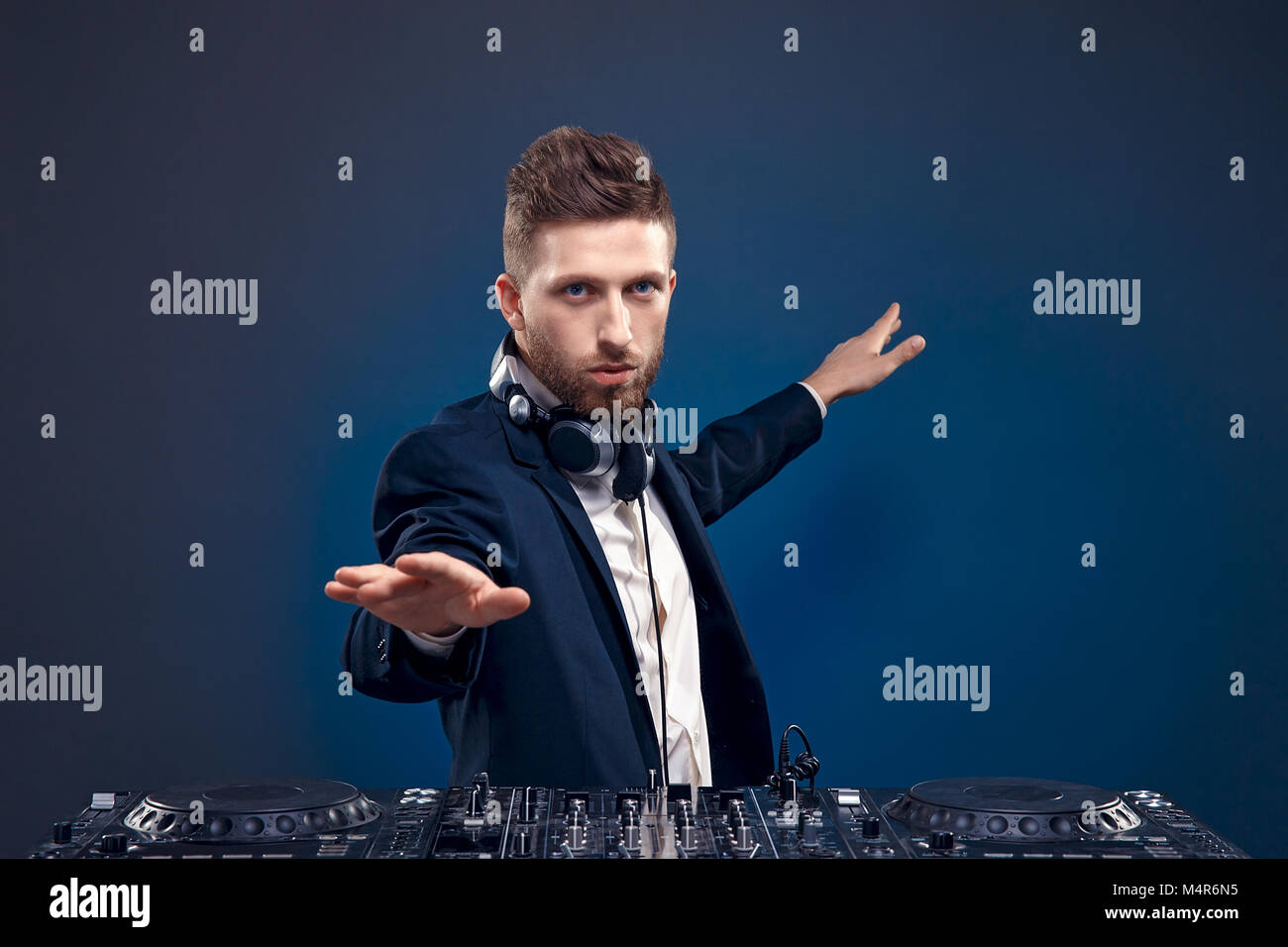 Closeup portrait of confident DJ with stylish hair style and headphones ...