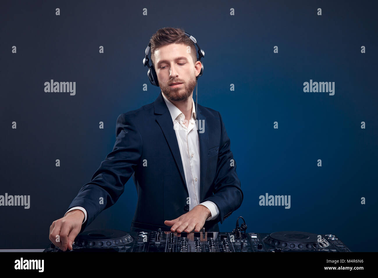 Closeup portrait of confident DJ with stylish hair style and headphones ...