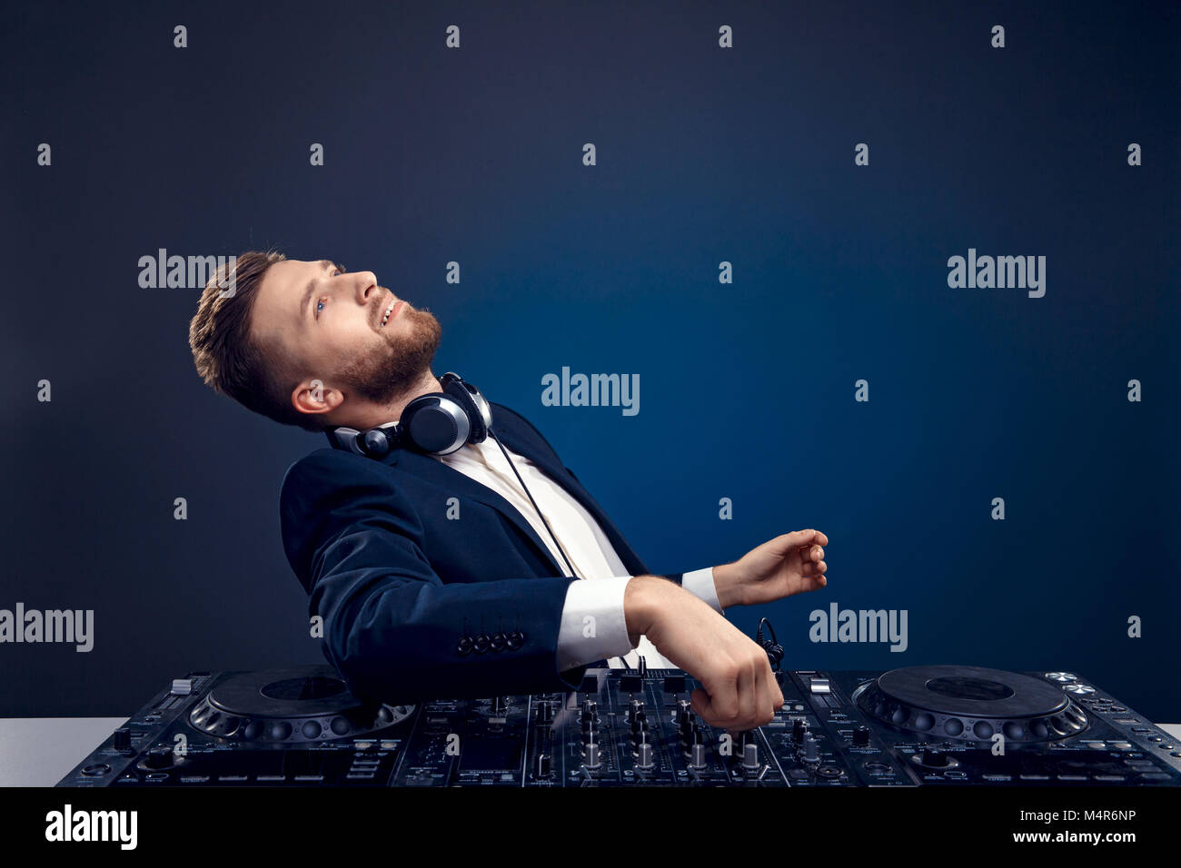 Closeup portrait of confident DJ with stylish hair style and headphones ...