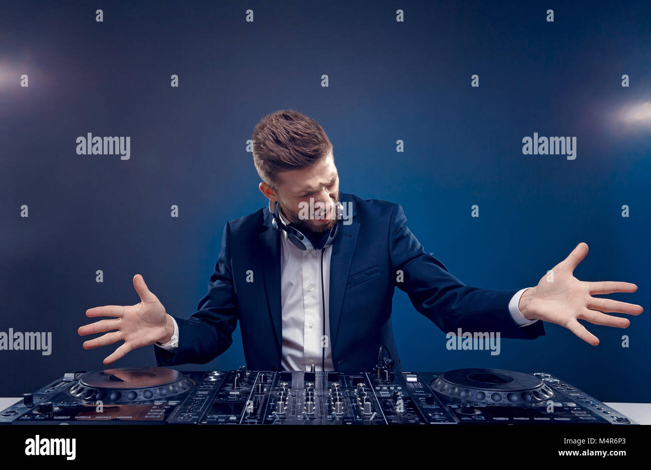 Closeup portrait of confident DJ with stylish hair style and headphones ...