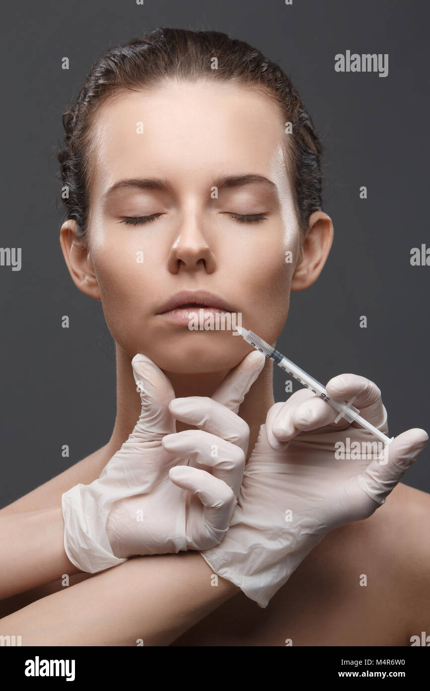 Portrait of young Caucasian woman getting cosmetic injection Stock ...