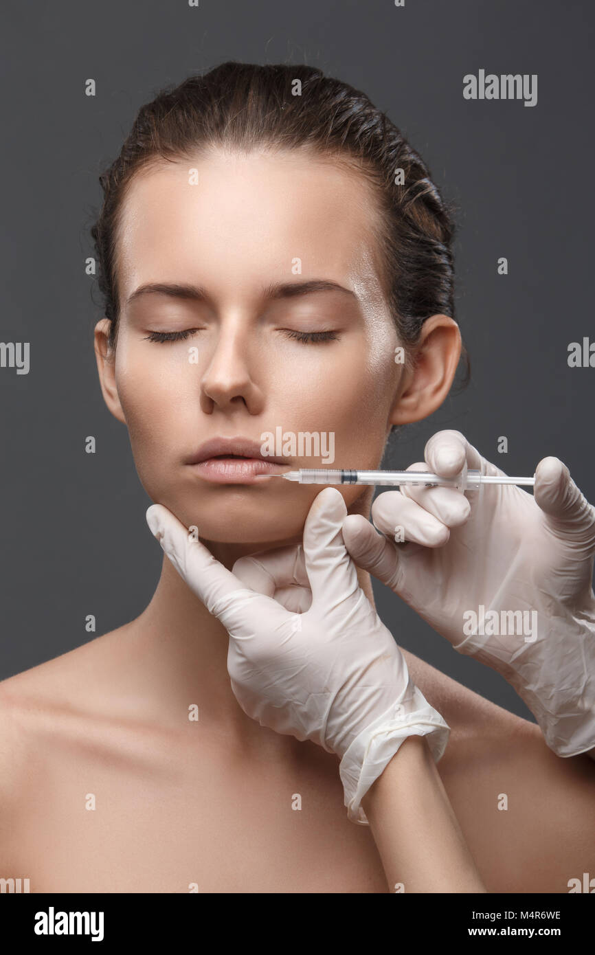 Portrait of young Caucasian woman getting cosmetic injection Stock ...