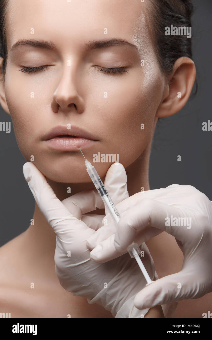 Portrait of young Caucasian woman getting cosmetic injection Stock ...