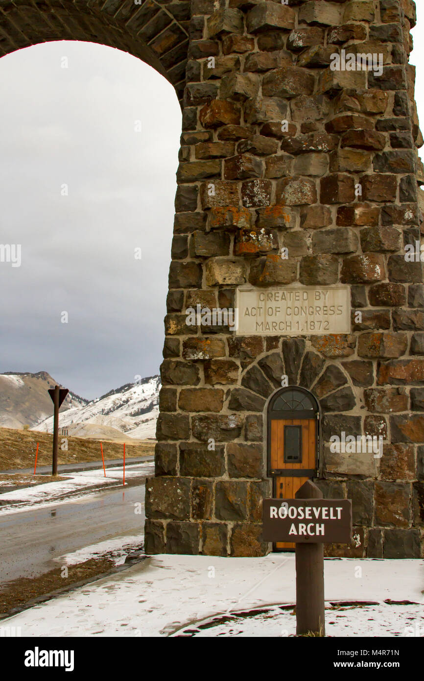 Dedication plaque over wooden door in stone Roosevelt Gate against snow ...